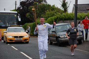 Dr Nigel Hart carries the Olympic torch | GPonline